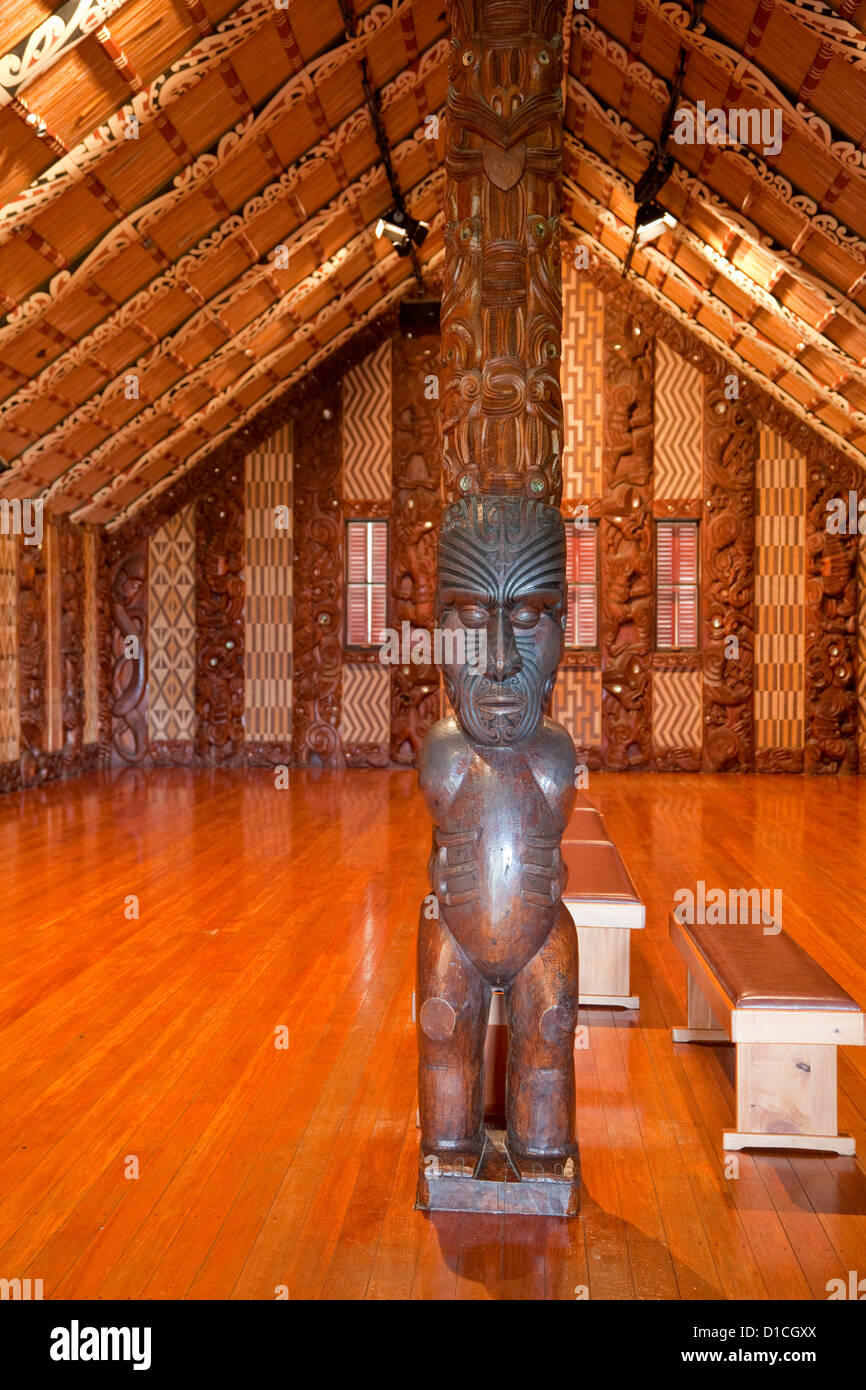 Carved Traditional Maori Figure, called pou-toko-manawa, supporting the ...
