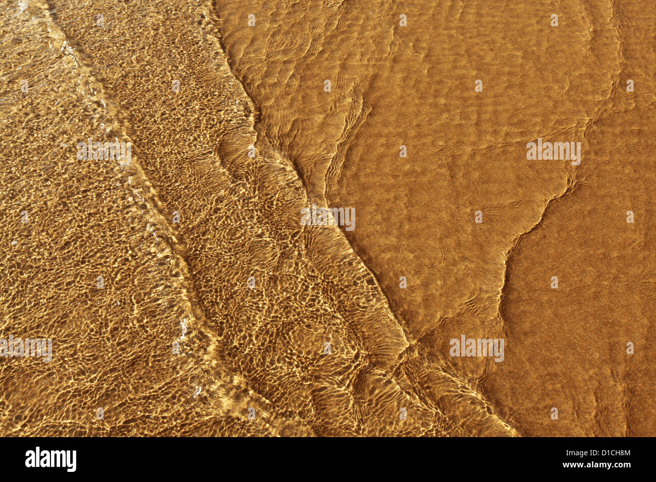 Wave and water shapes on a beach shoreline Stock Photo - Alamy