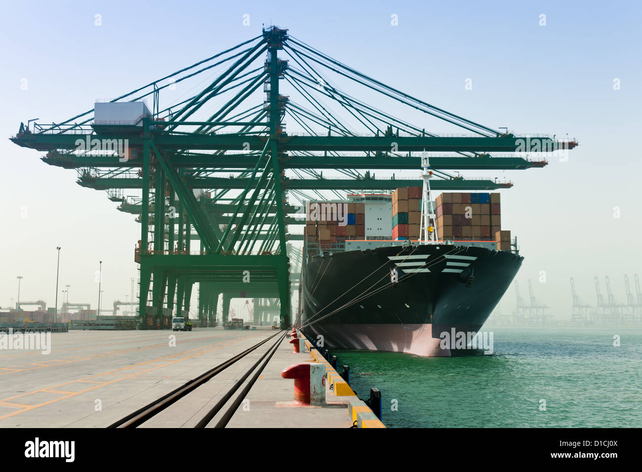 Loading container ship at port Stock Photo - Alamy