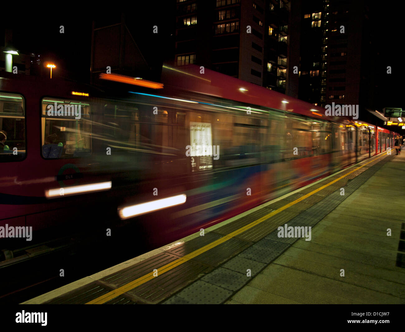 DLR train arriving at East India DLR station at night, Leamouth London ...