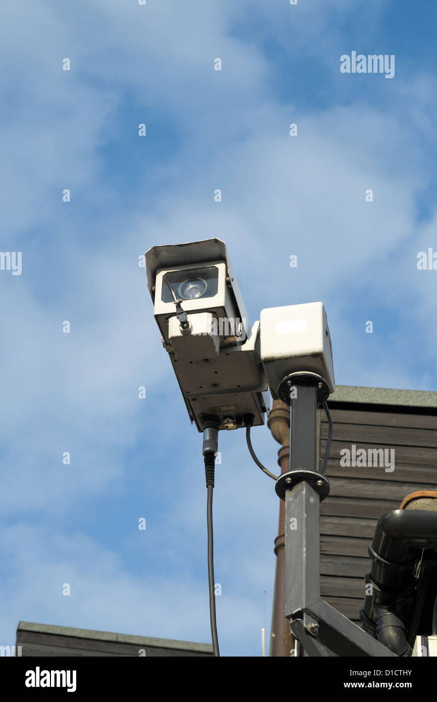 Looking up at CCTV camera against blue sky and white clouds Stock Photo ...
