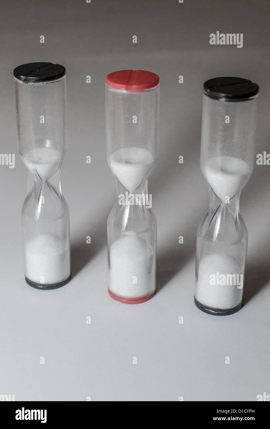 Three Hourglasses In A Row Stock Photo - Alamy