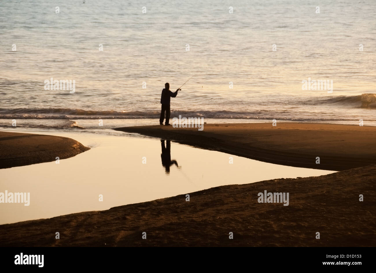 An angler enjoying early morning peace Stock Photo - Alamy
