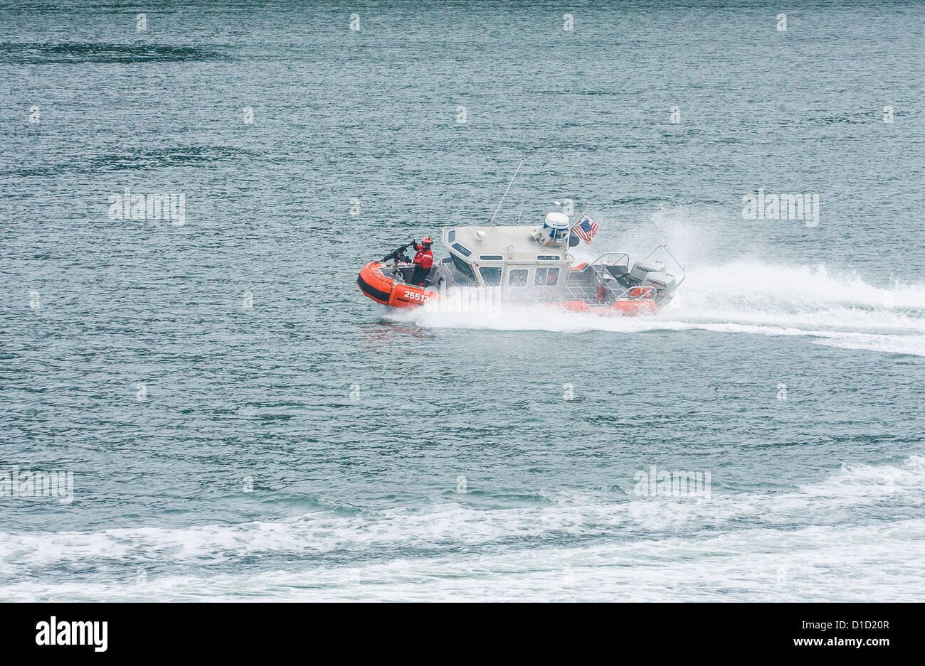 A United States coast guard boat cruising through a large harbor Stock ...
