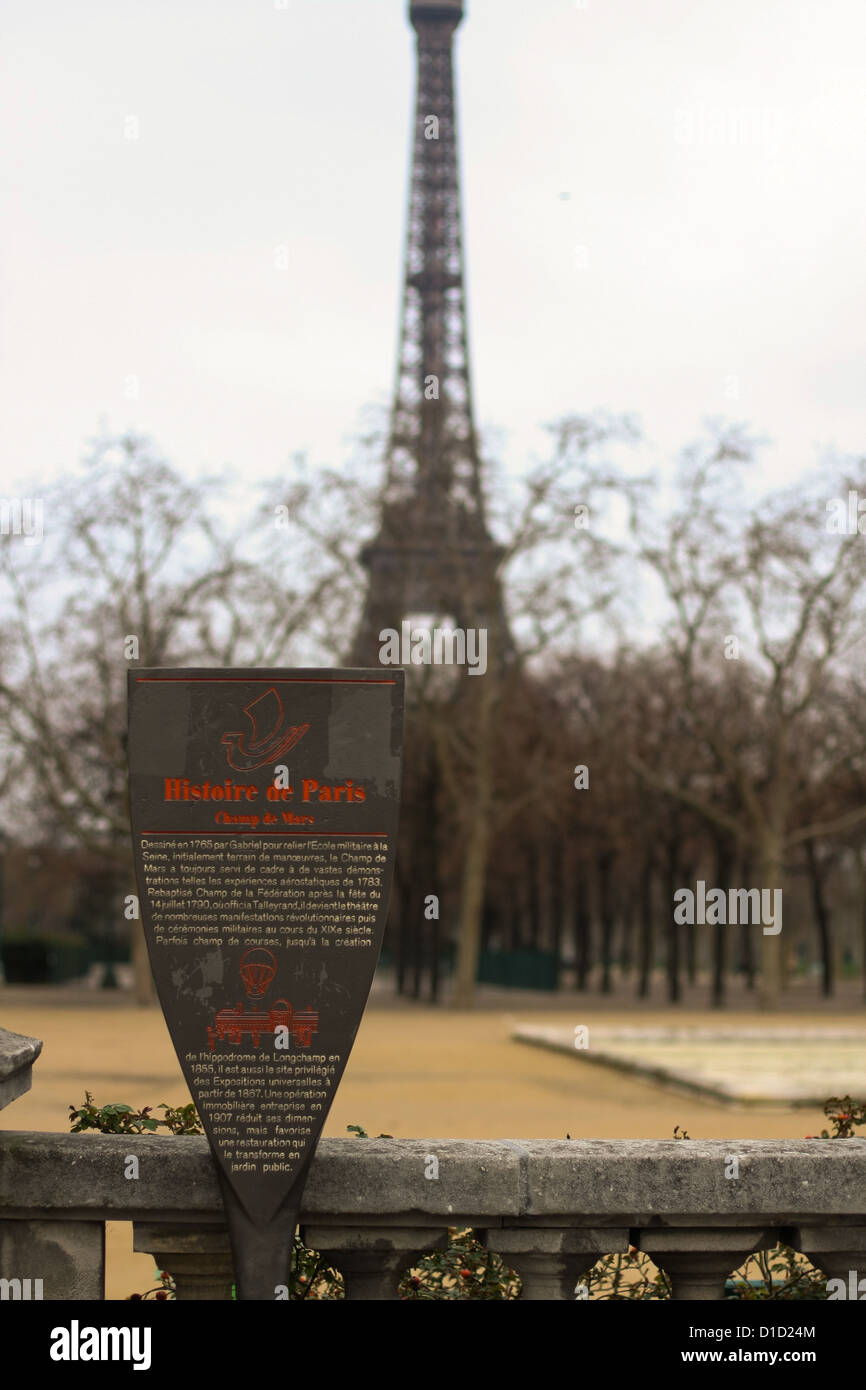 A 'History of Paris' panel is displayed along a sidewalk in Paris with ...