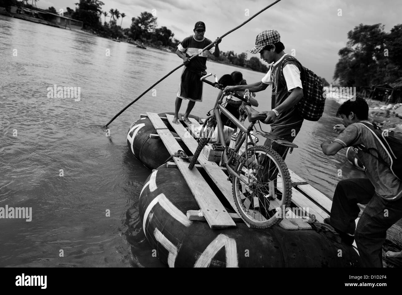 Guatemalan border area workers get on a makeshift inner tube raft to ...