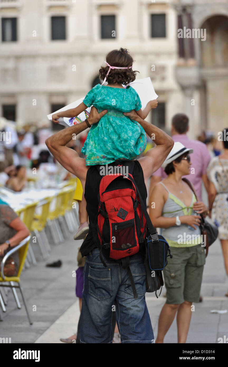 Father carrying child on shoulders, Venice, Italy Stock Photo - Alamy