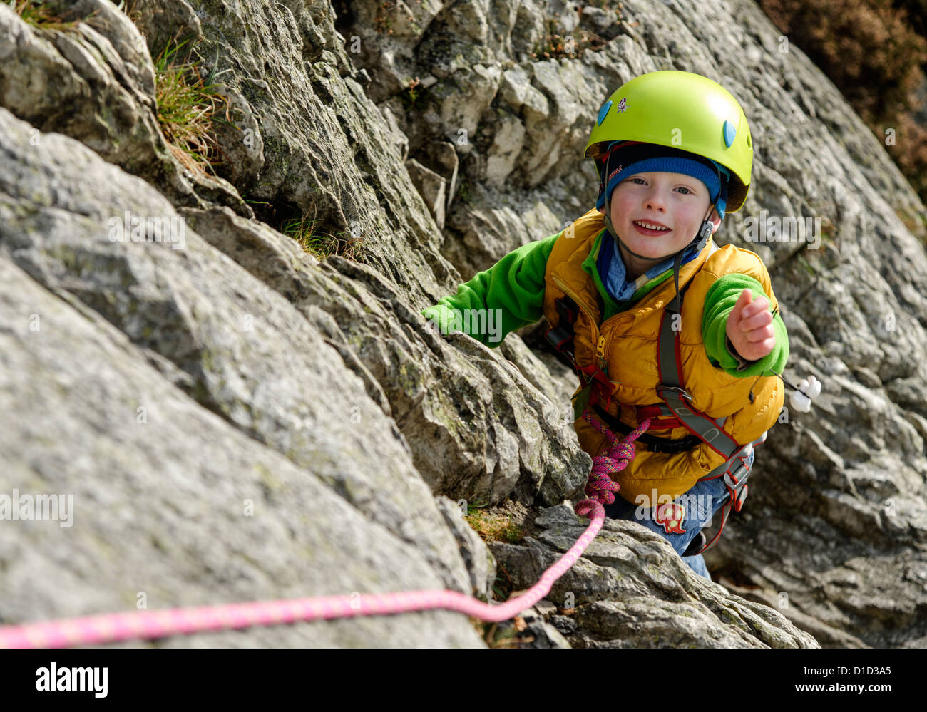 A young boy climbing on an outdoor cliff Stock Photo - Alamy