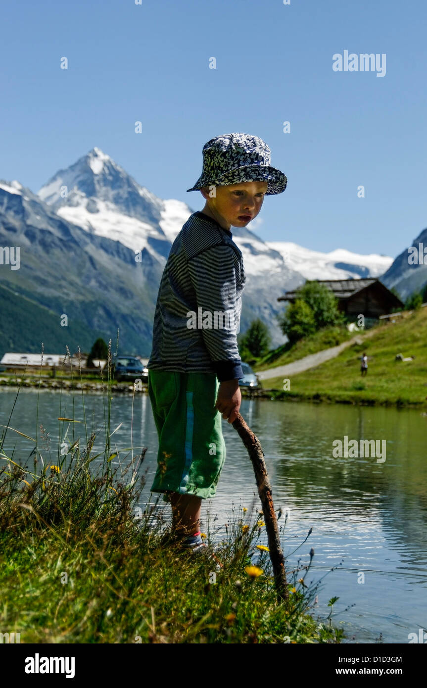 A boy standing next to a pool of water Stock Photo - Alamy