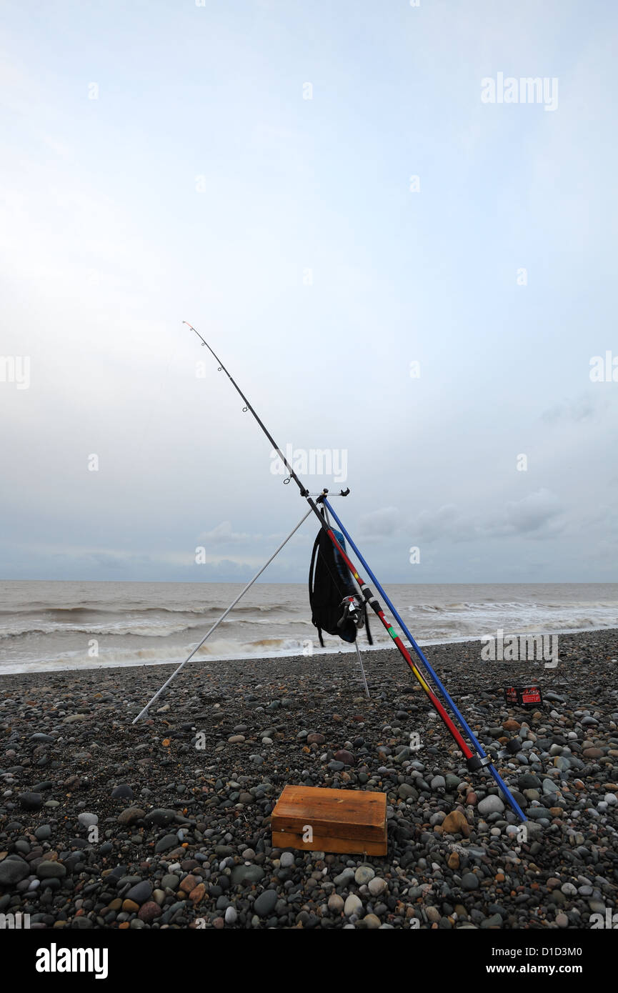 Fishing rod on a beach at high tide Stock Photo - Alamy