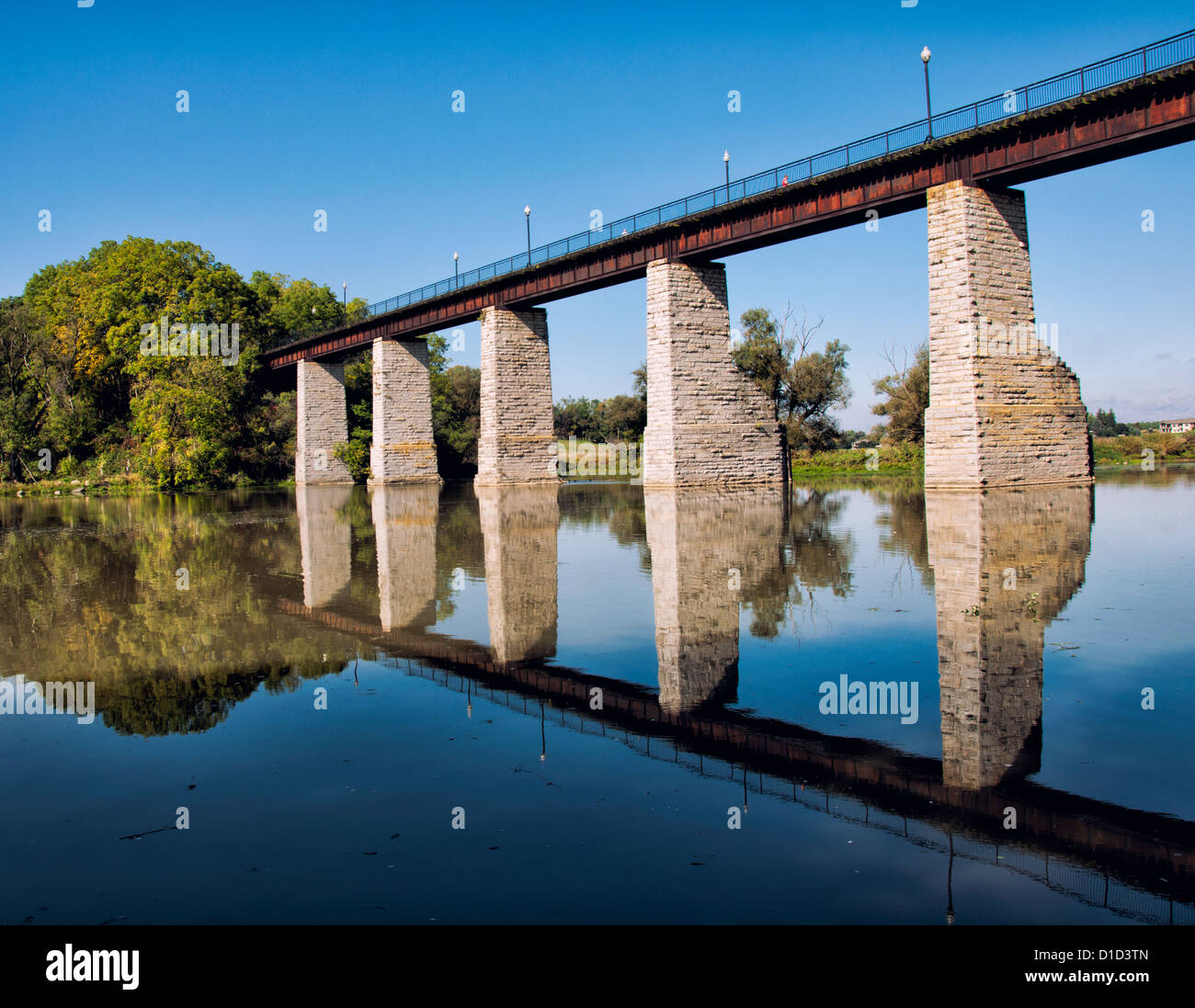 Historic railroad trestle over river with reflection in the river Stock ...