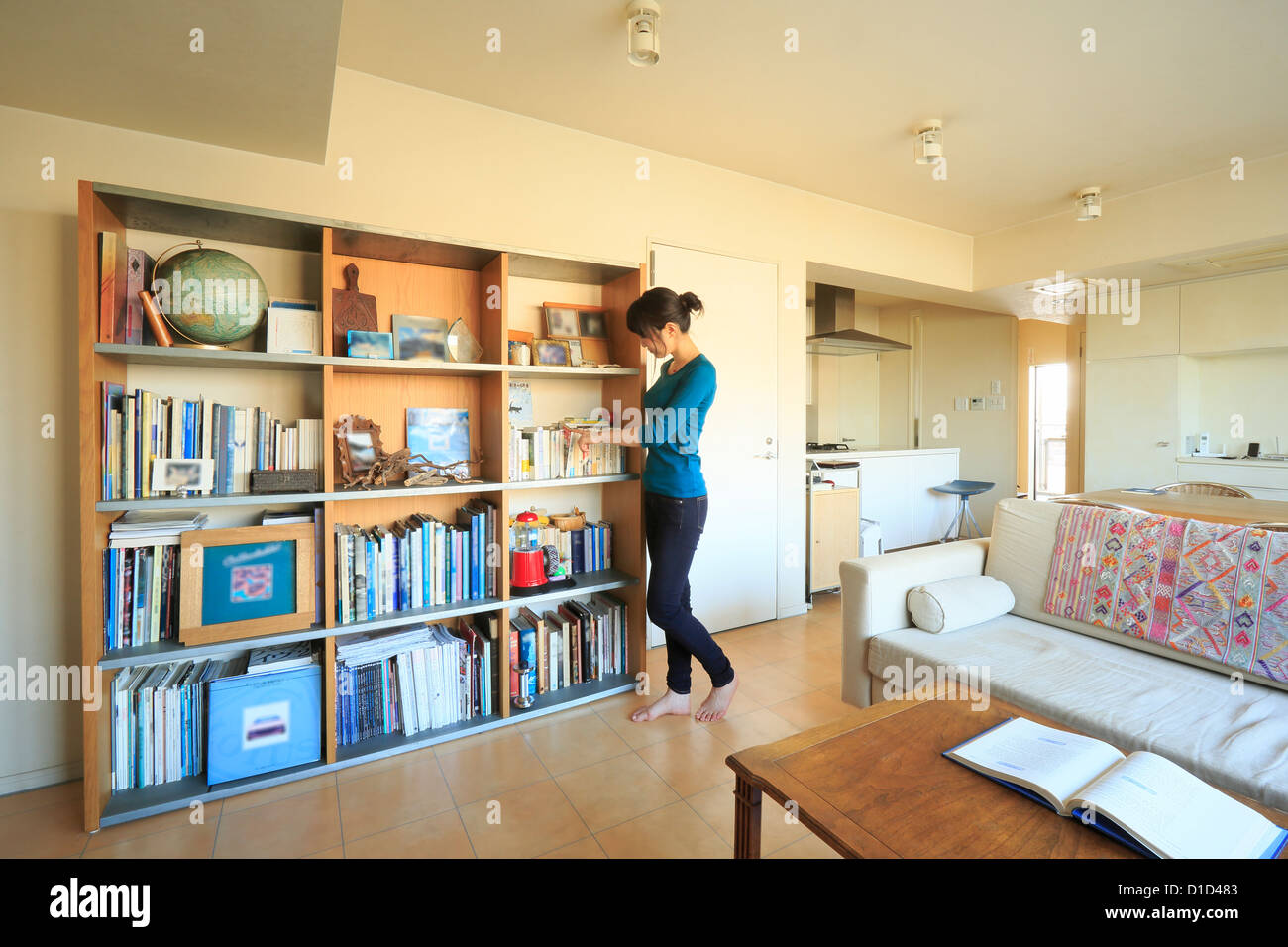 Young Woman Standing at Living Room Stock Photo - Alamy