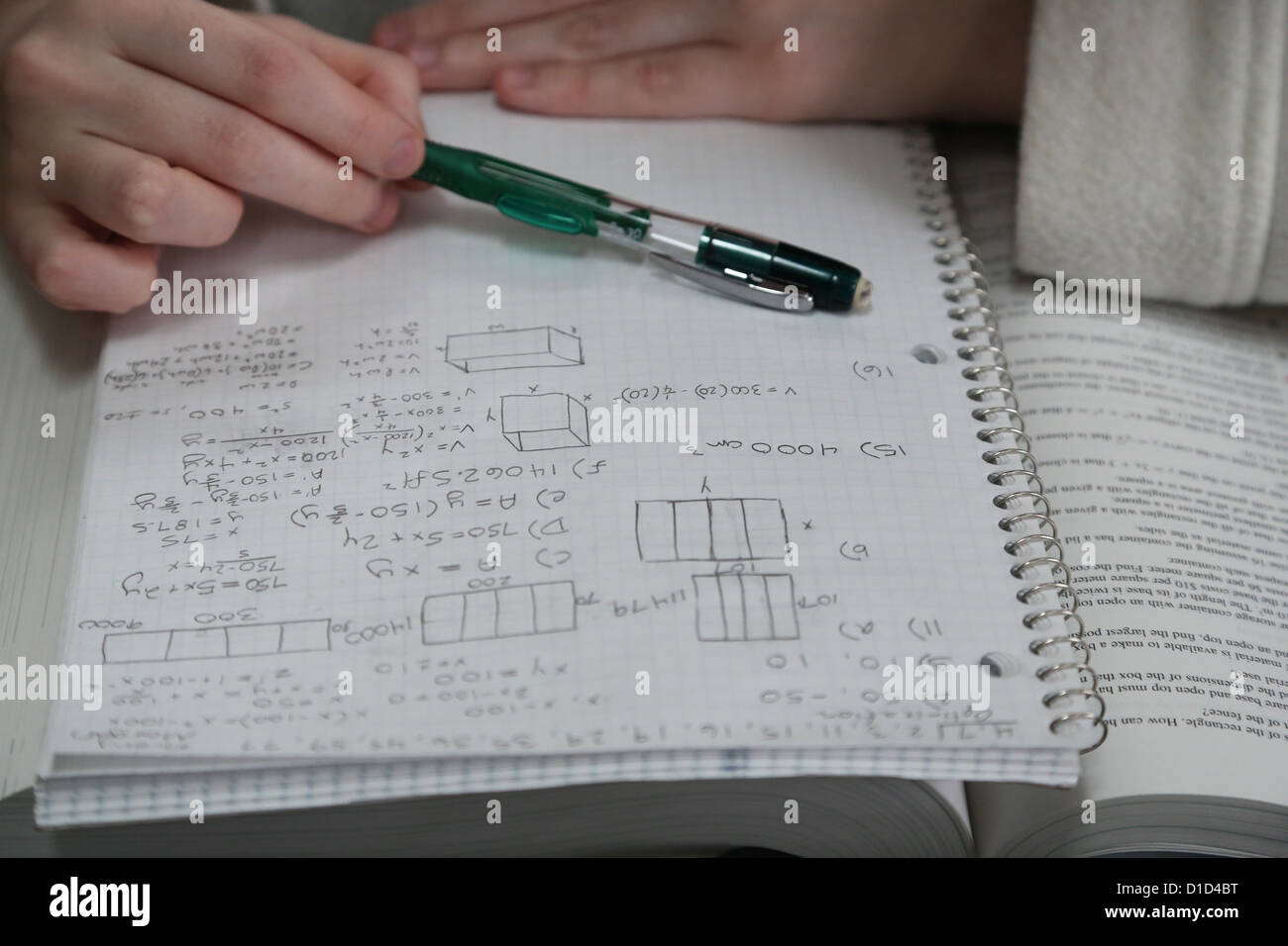 A close up of a teen working an calculus problem on paper Stock Photo ...