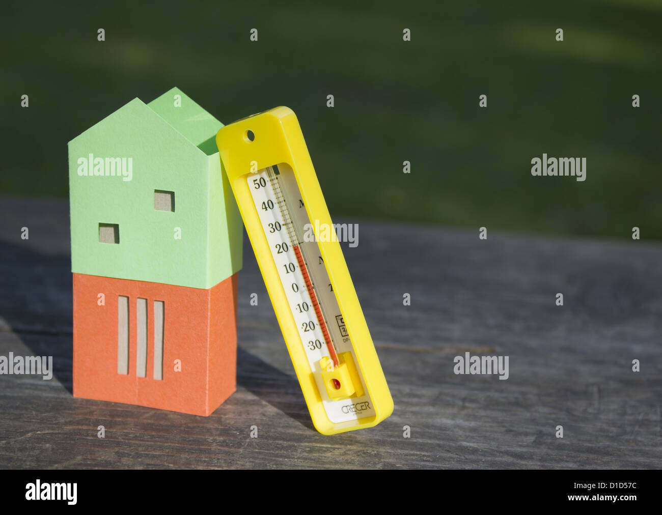 Miniature house and a thermometer Stock Photo - Alamy