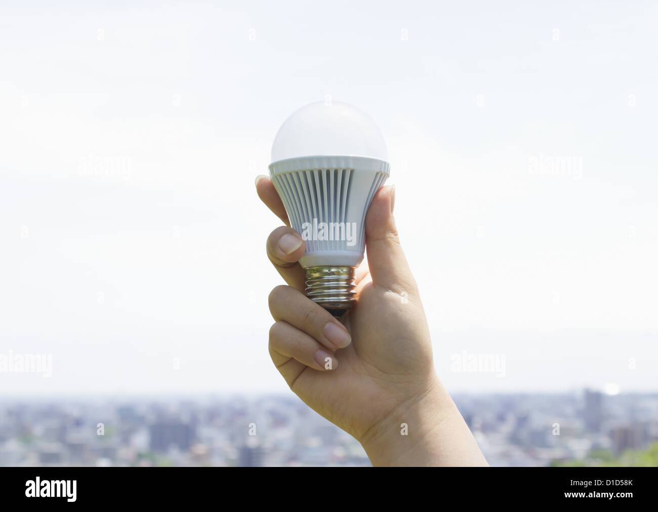 Hand holding a LED bulb Stock Photo - Alamy
