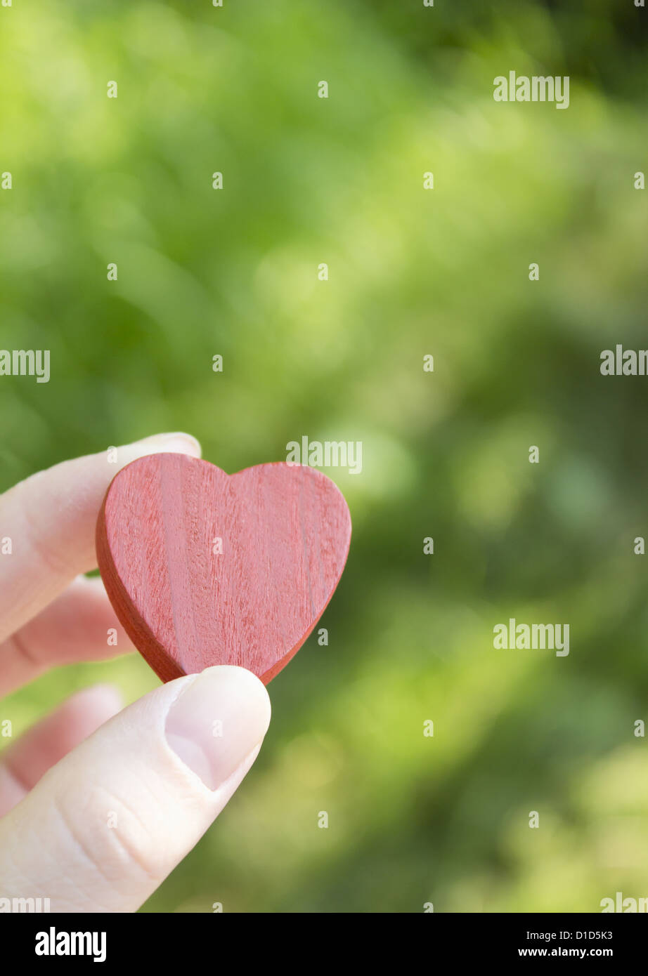 Hand holding a heart Stock Photo - Alamy