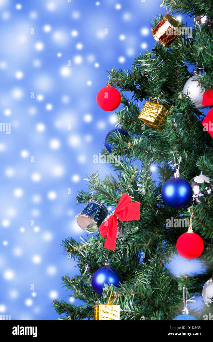 a close up christmas toys on a tree snowing Stock Photo - Alamy