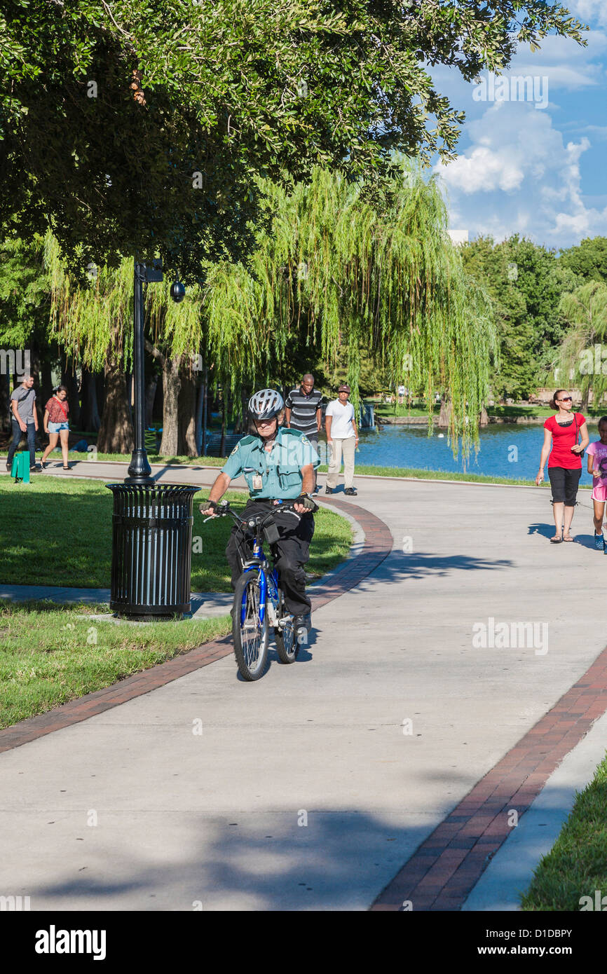 Security officer guard riding bicycle through Lake Eola Park in ...