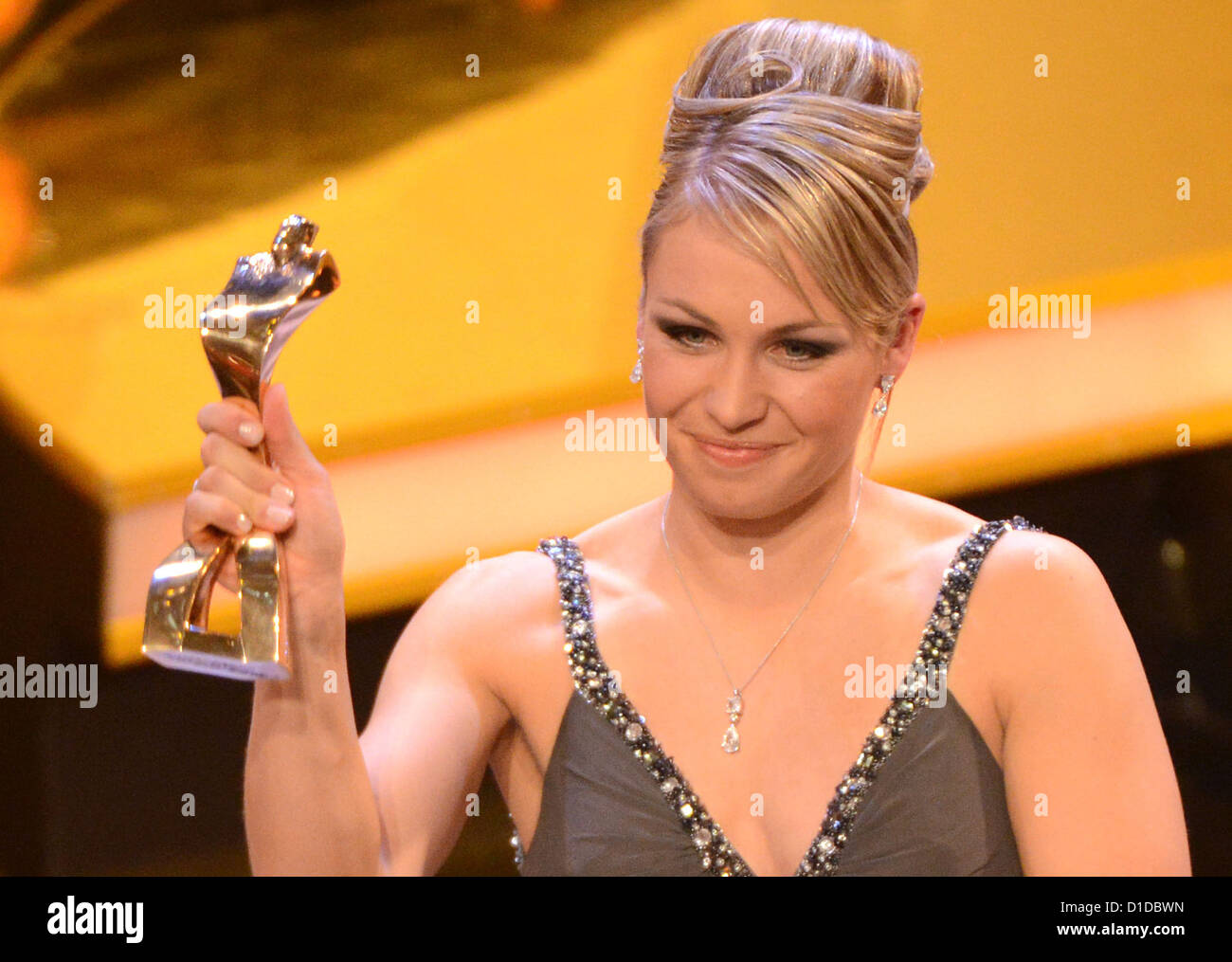 Former biathlete Magdalena Neuner holds her trophy after the ...