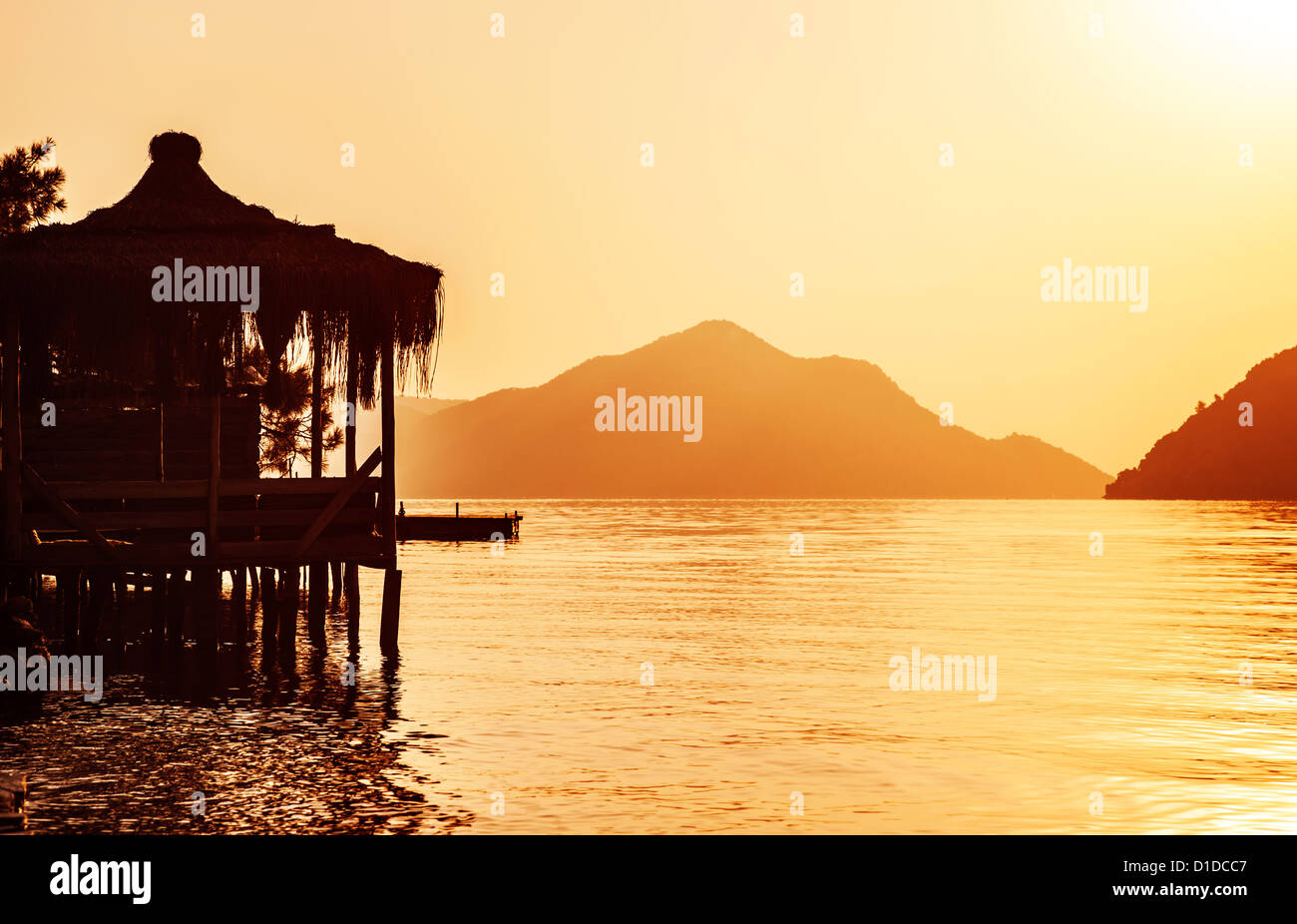 Image of Asian coastal luxury resort, beautiful little hut on the water ...