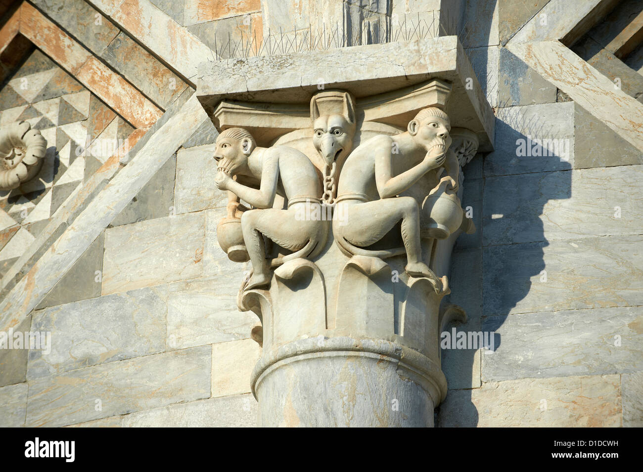 Grotesque Medieval pillar capital sculpture on the exterior of the ...