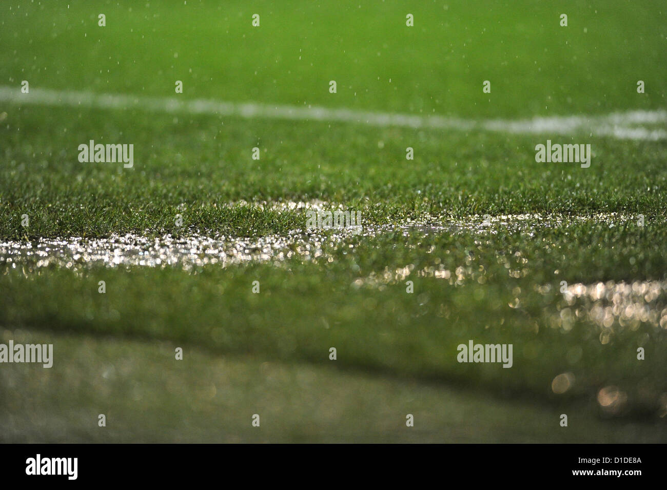 Heavy rain falling on waterlogged turf football pitch with standing ...