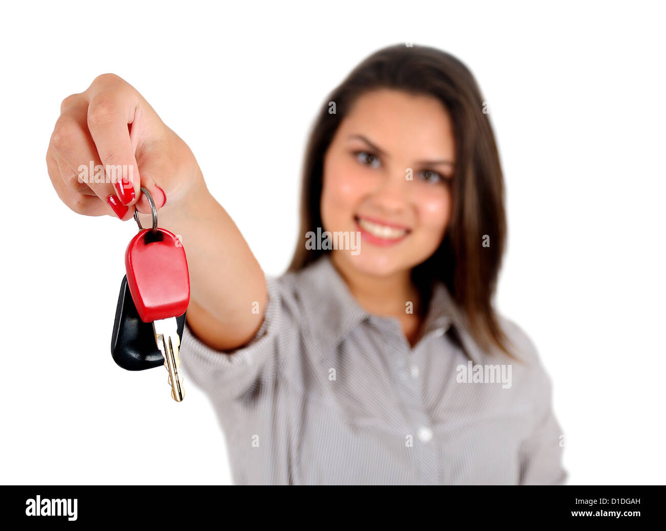 Isolated young business woman showing key Stock Photo - Alamy