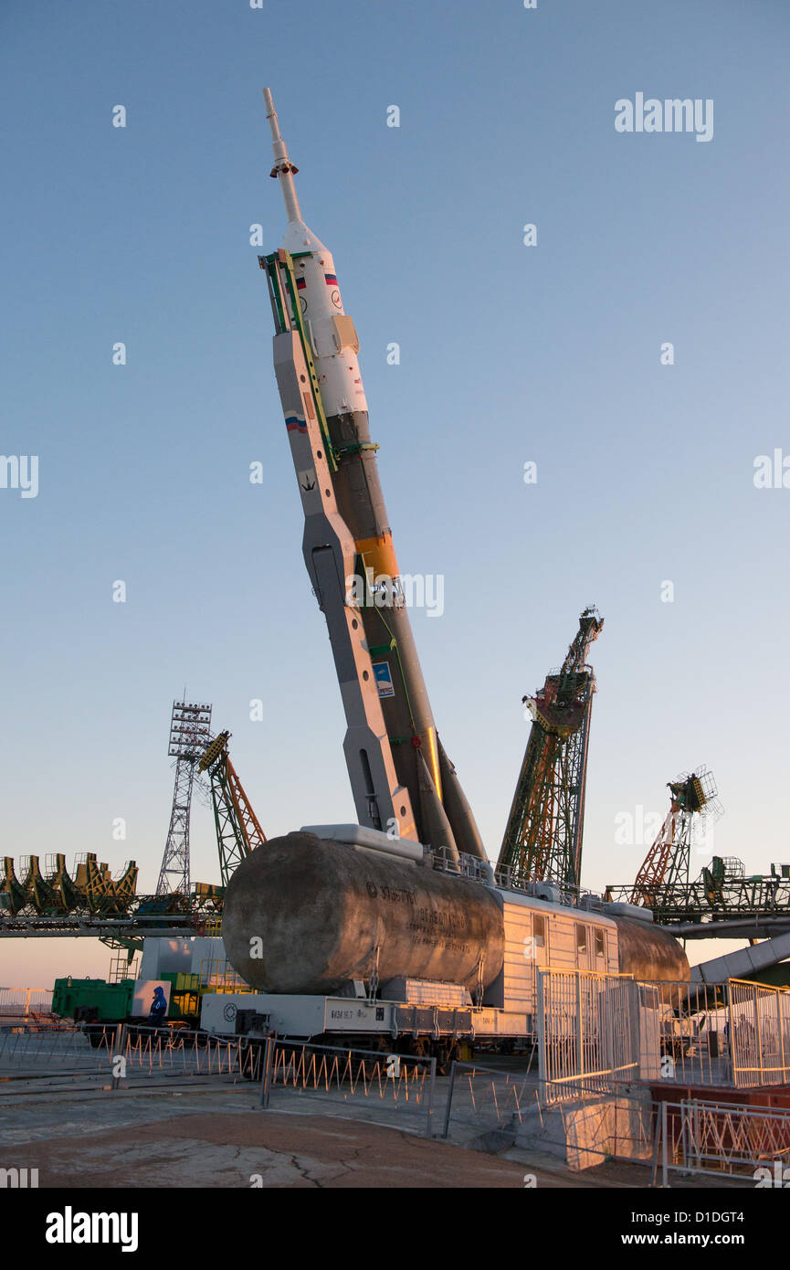 A Soyuz rocket is lifted into position after roll out to the launch pad ...