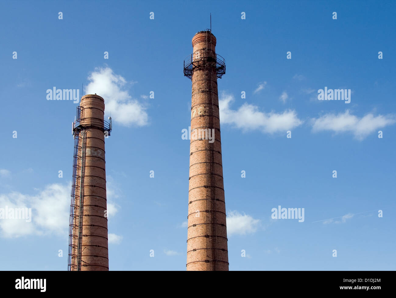 Two old brick chimneys with lightning rods against a blue sky Stock ...