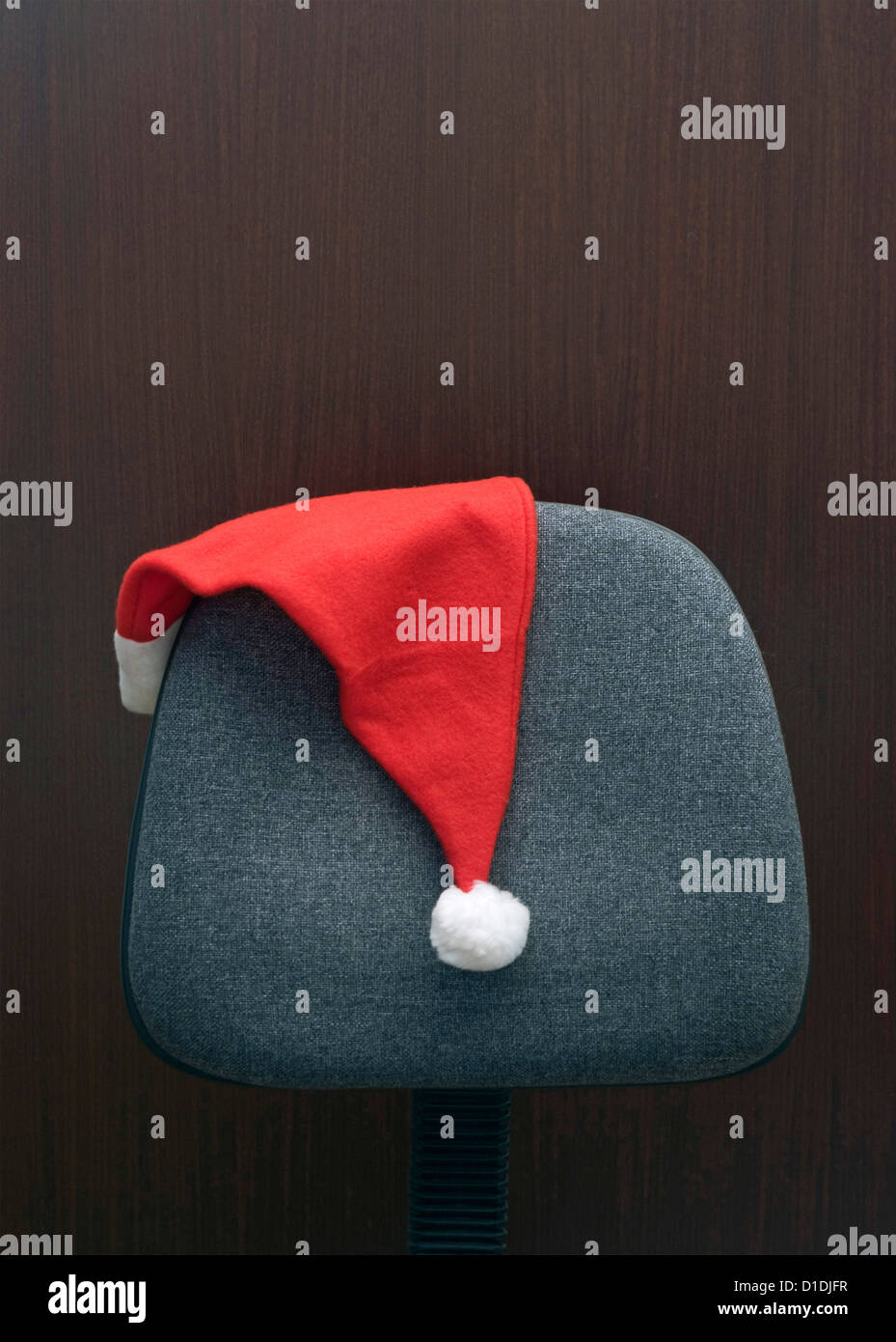 a Santa Claus hat left on chair Stock Photo - Alamy