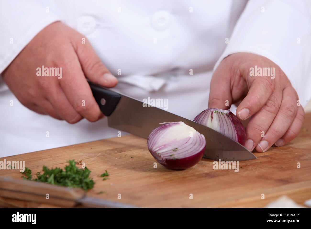 Chef chopping a red onion Stock Photo - Alamy