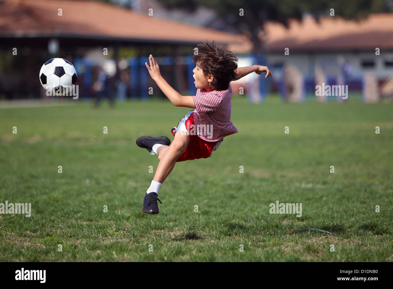 Boy playing soccer in the park - authentic action - horizontal with ...