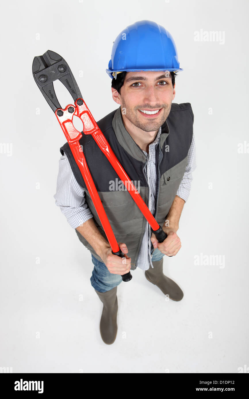 Construction worker holding large pliers Stock Photo - Alamy