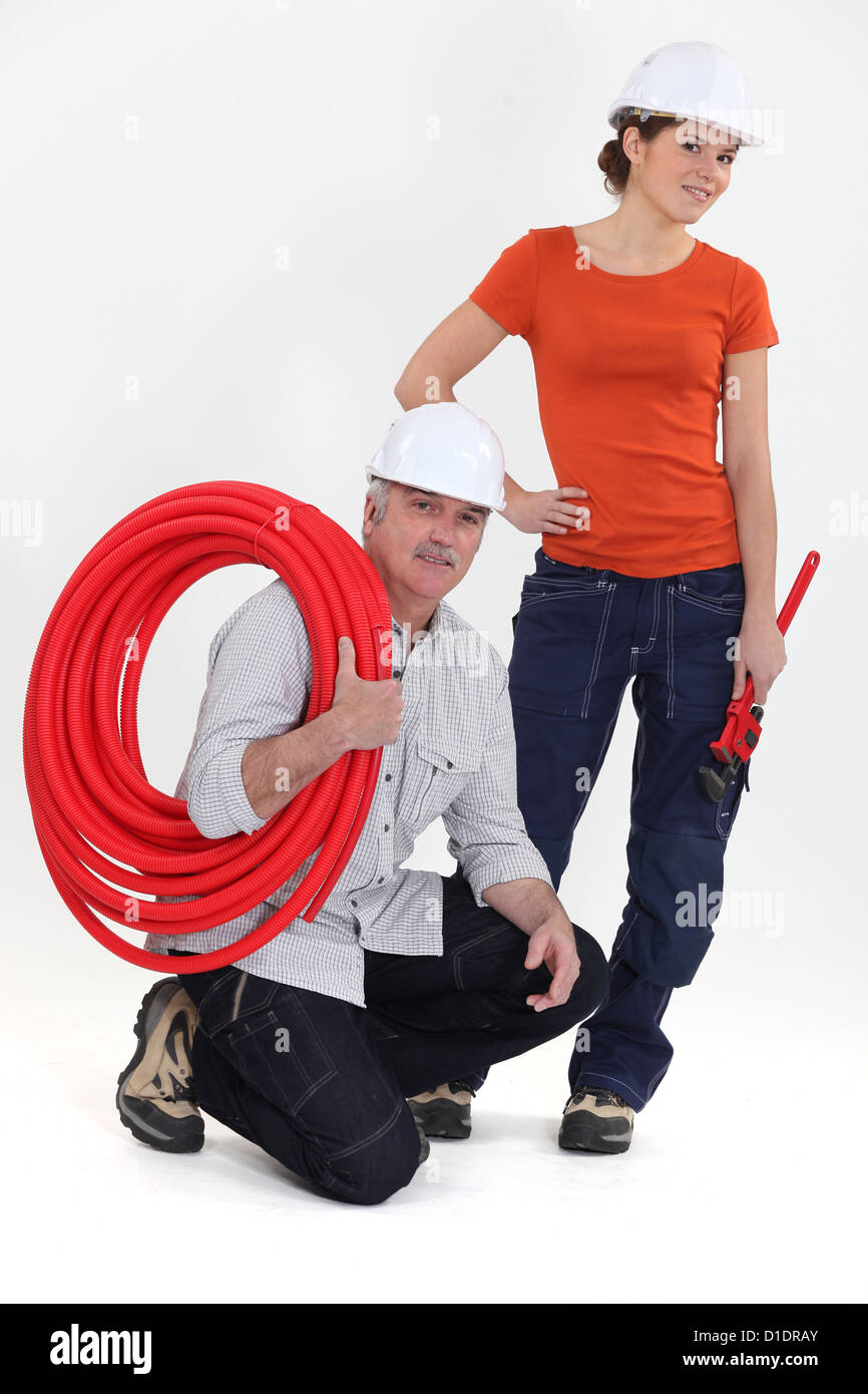 plumber and young apprentice posing Stock Photo - Alamy