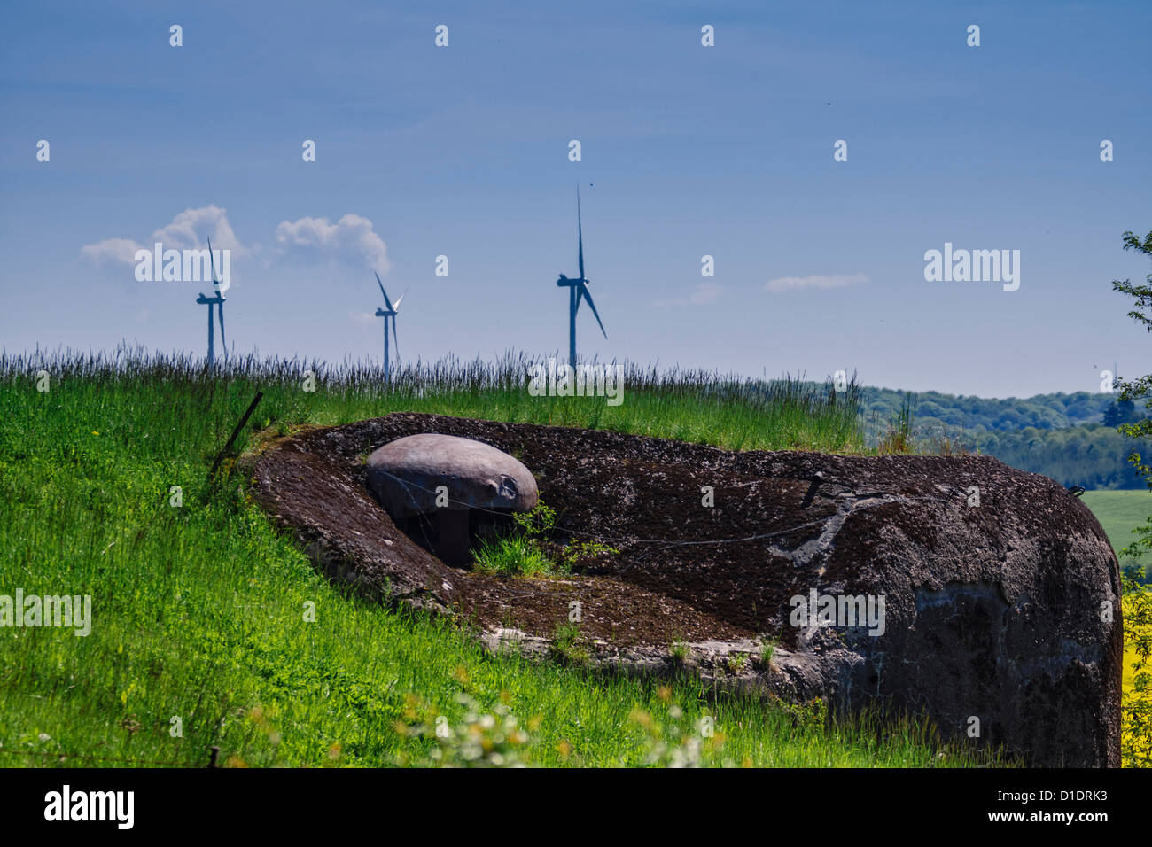 La Ferte, France. Wind turbines tower over an old fort of the Maginot ...