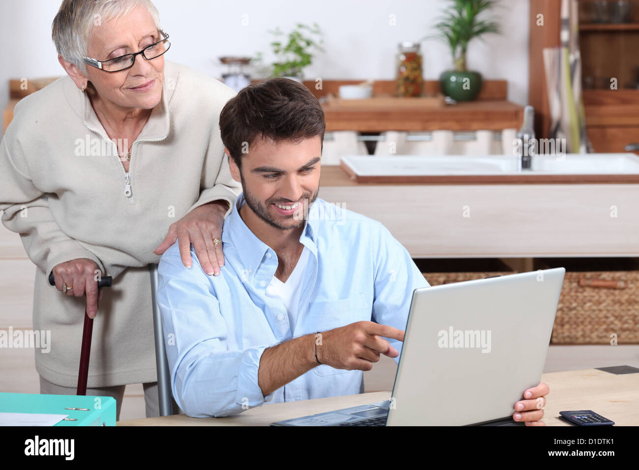 Man showing old lady how to use computer Stock Photo - Alamy