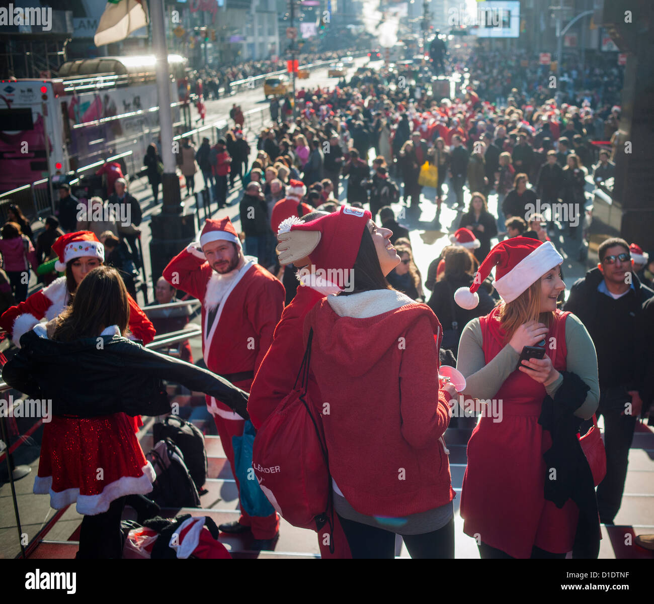Christmas revelers participating in the annual Santacon flood midtown ...