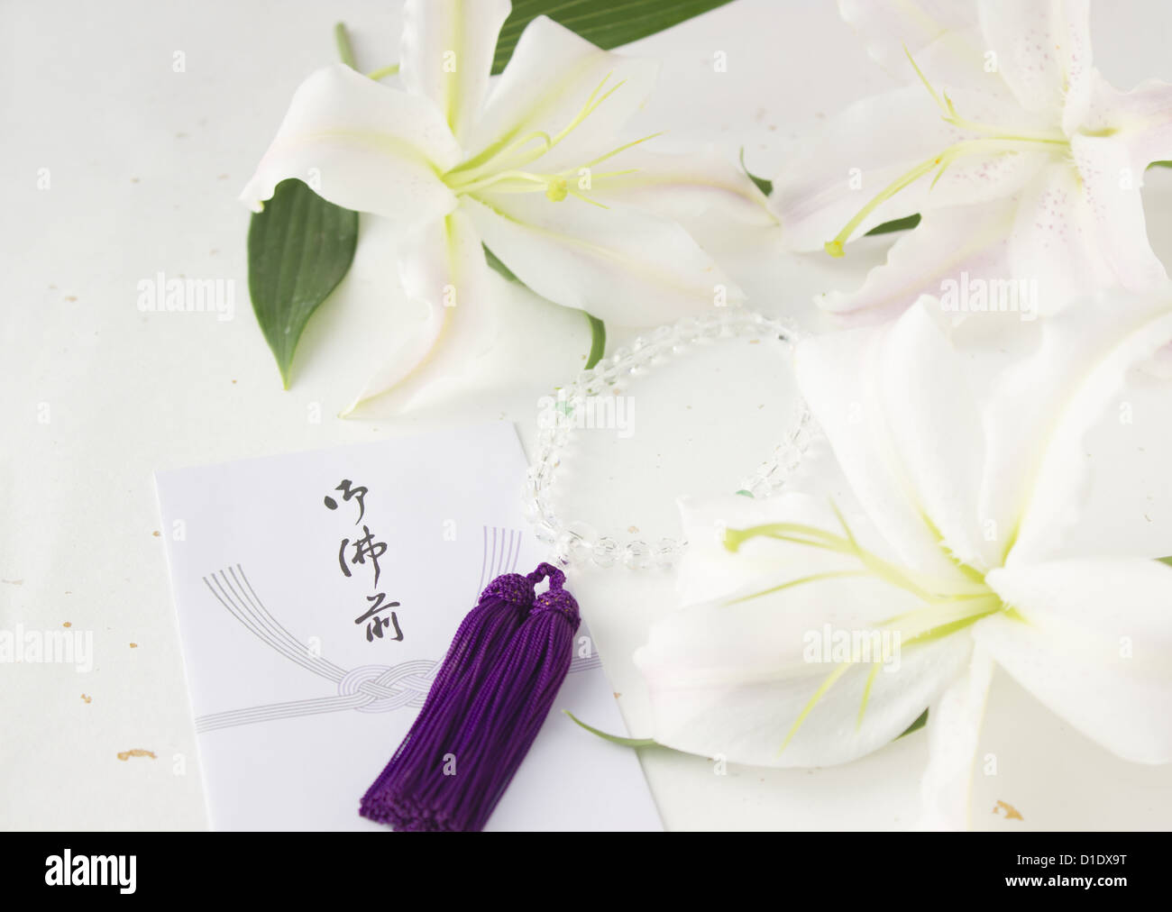 Lilies, a condolence-money envelop, and a Buddhist rosary (Mourning ...