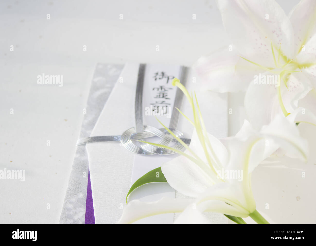 Lilies and a condolence-money envelop (Mourning image Stock Photo - Alamy
