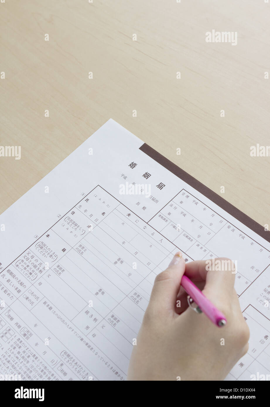 Woman's hand filling in a marriage form Stock Photo - Alamy