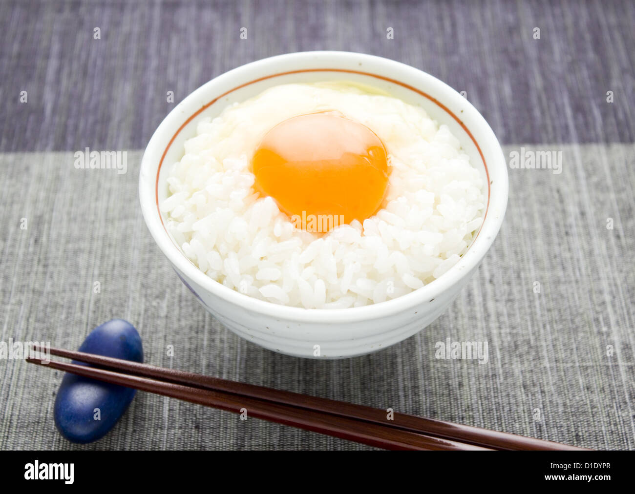 Raw egg sauce over rice Stock Photo - Alamy