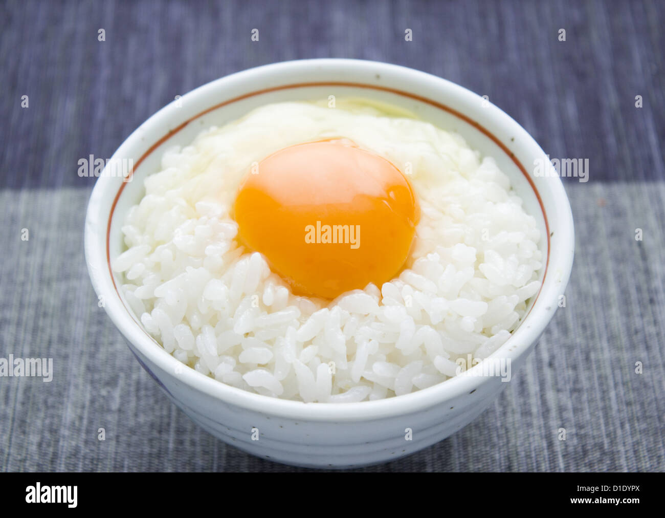 Raw egg sauce over rice Stock Photo - Alamy