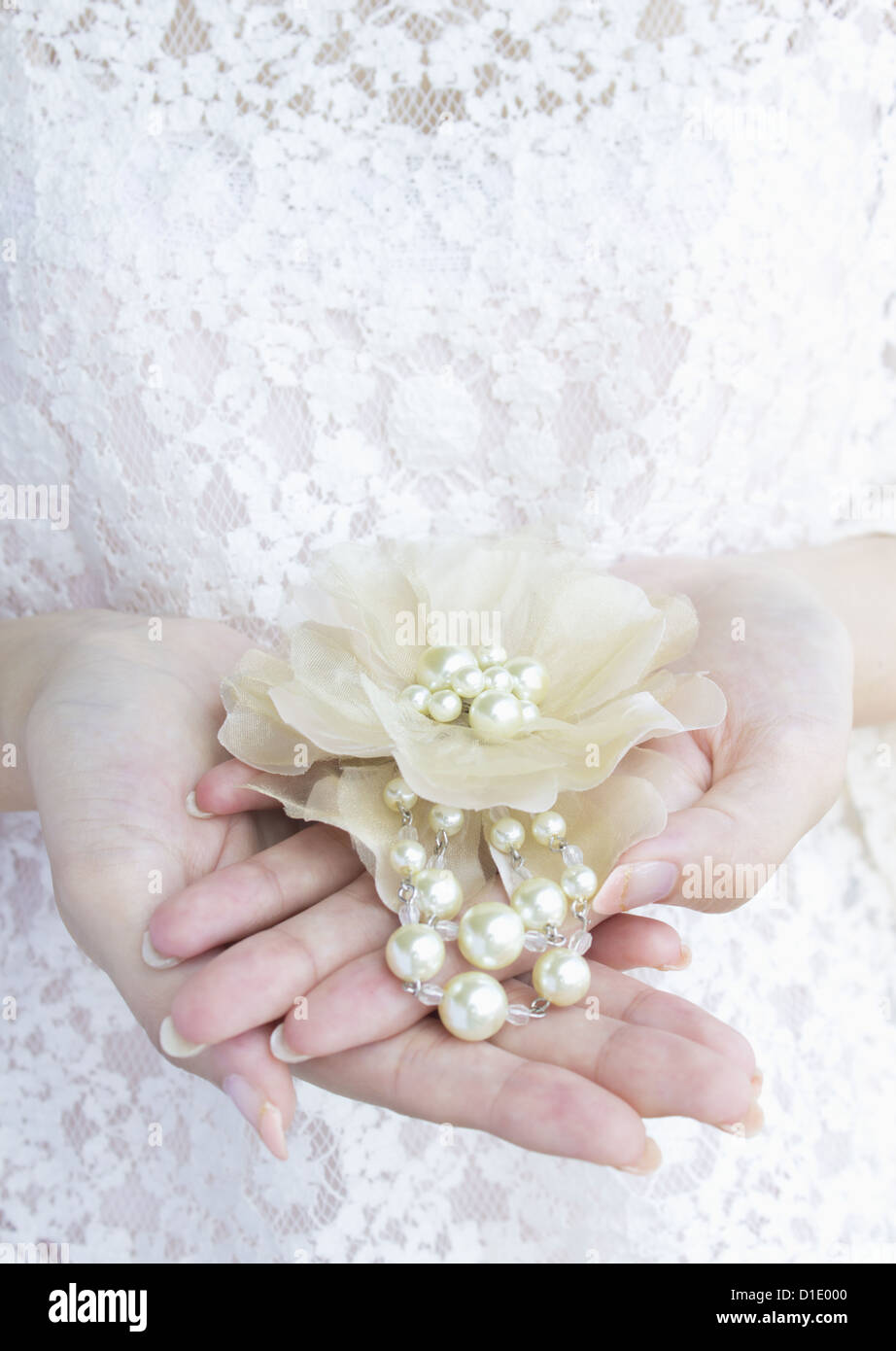 Hands holding a pearl accessory Stock Photo - Alamy