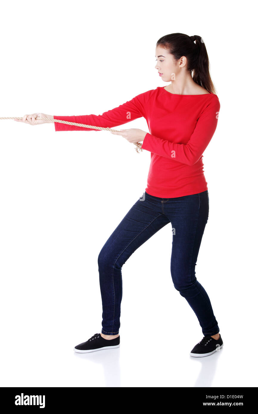 Casual woman pulling a rope, isolated on white Stock Photo - Alamy