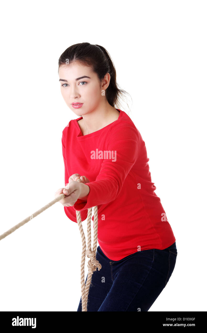 Adultl woman pulling a rope, isolated on white Stock Photo - Alamy