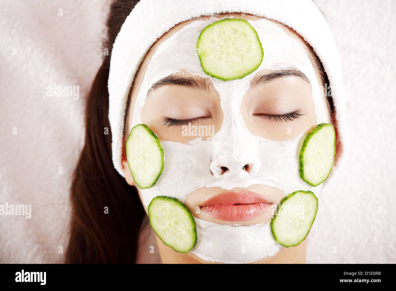 Young woman with cucumber slices on the face in a spa saloon Stock ...