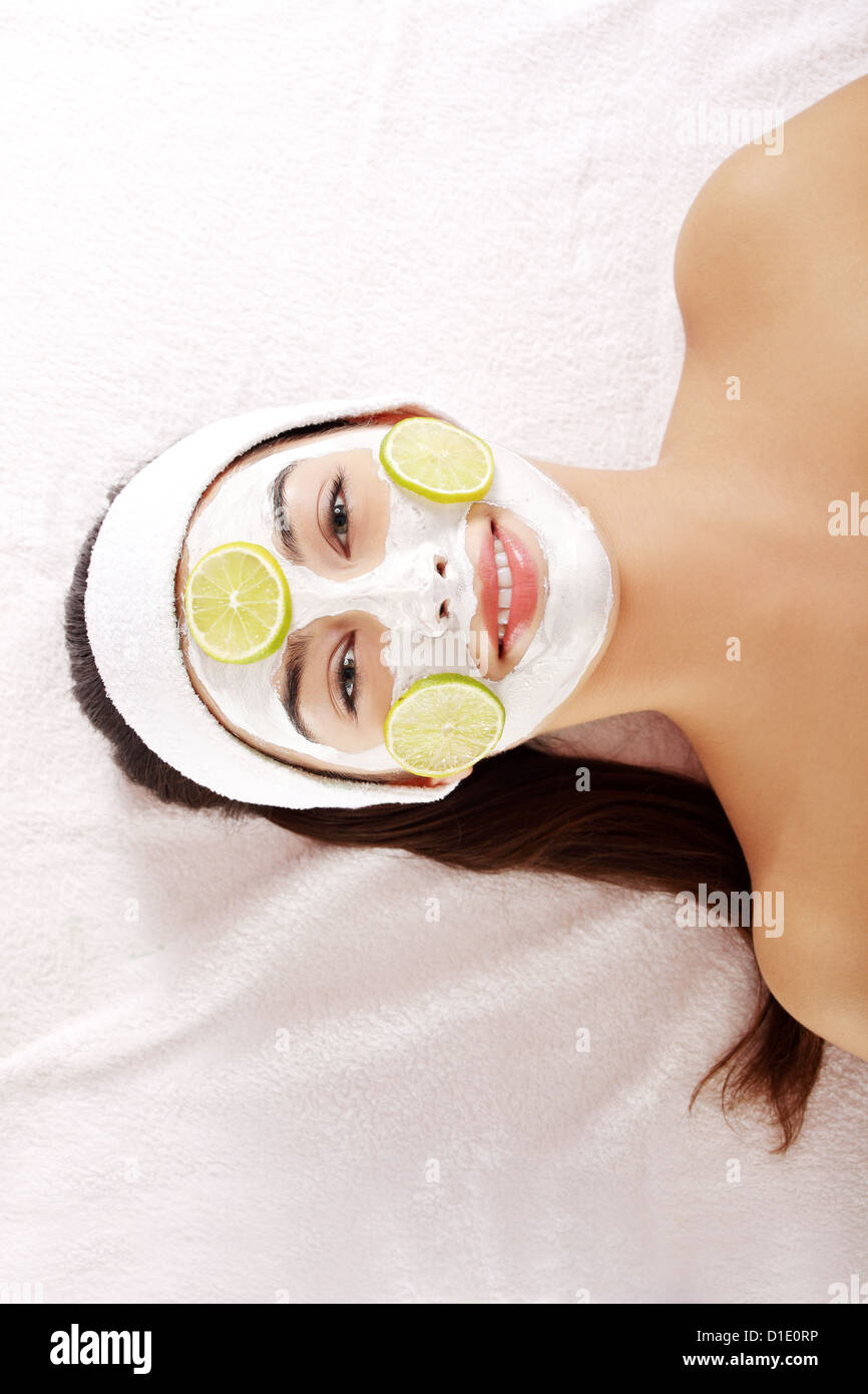 Attractive young woman with fruit mask on a face at spa saloon Stock ...