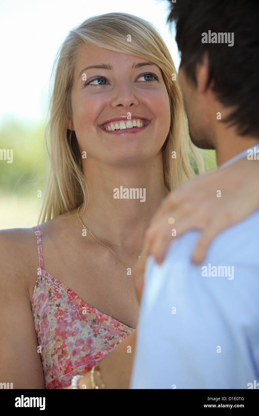 Smiling girlfriend looking adoringly at her boyfriend Stock Photo - Alamy
