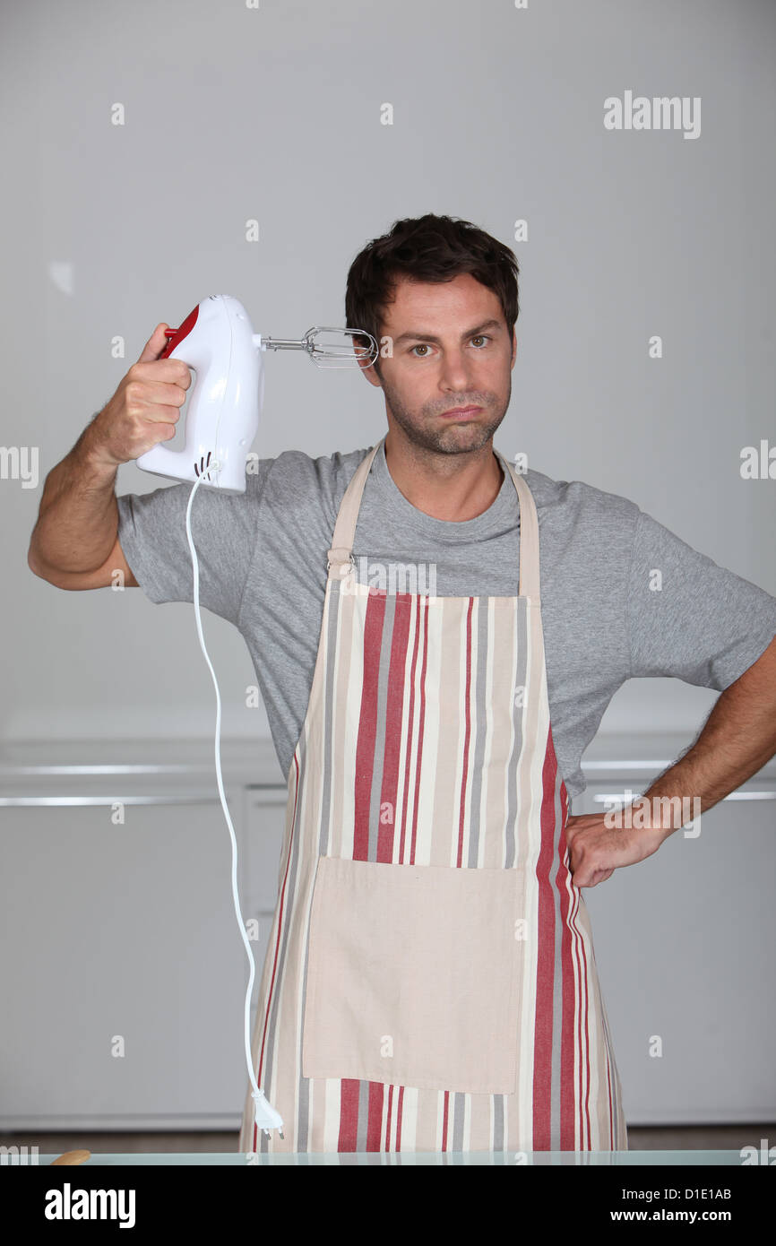 Man with an electric whisk Stock Photo - Alamy