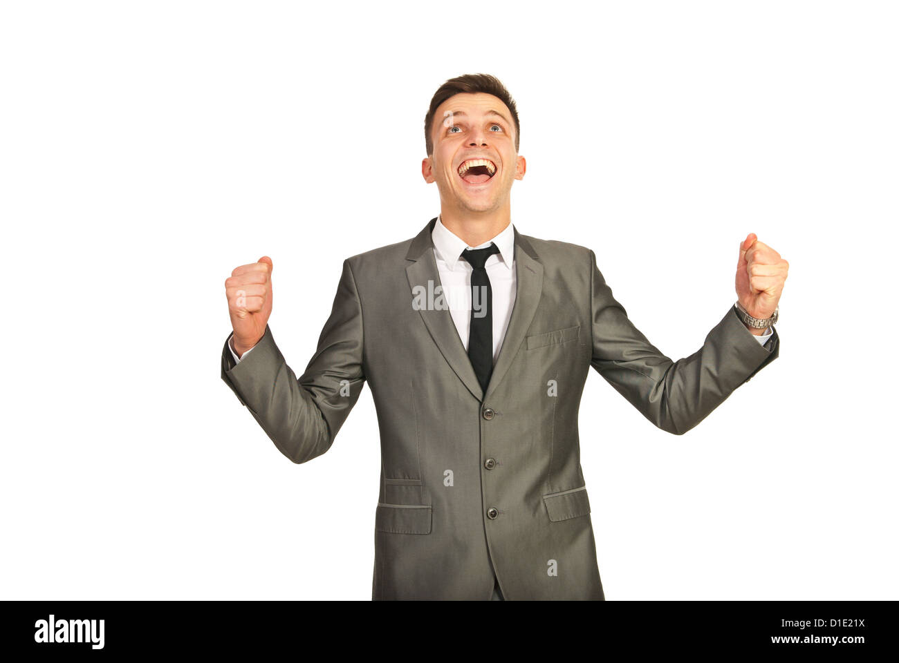 Happy winner business man looking up and cheering isolated on white ...